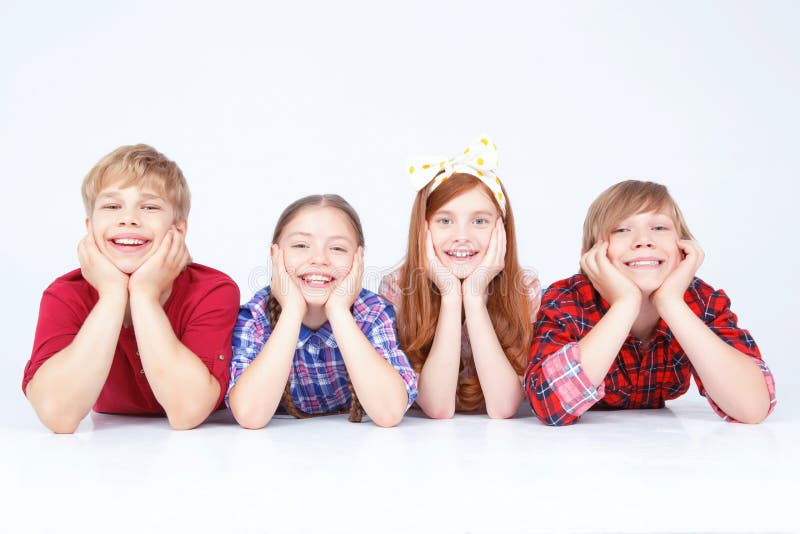 Smiling Children Lying on the Floor in Raw Stock Photo - Image of ...