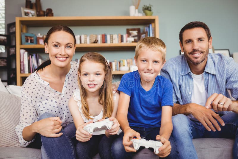 Smiling Children Playing Video Games with Parents Stock Photo - Image ...