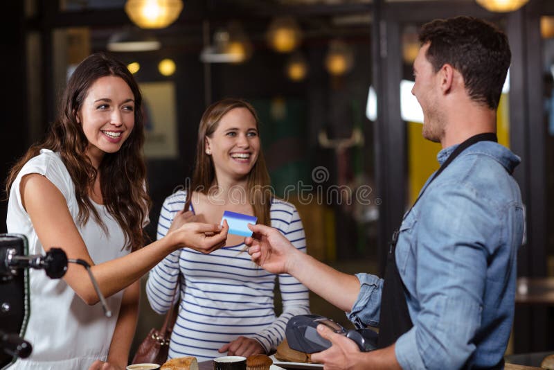 Smiling Clients Paying with Card Stock Photo - Image of communication ...