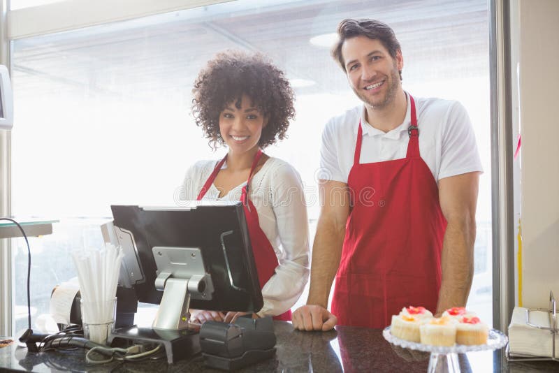 Smiling Co-workers Posing Together Behind the Counter Stock Image ...