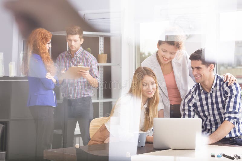 Smiling Co-workers Using Laptop Stock Photo - Image of female, career ...