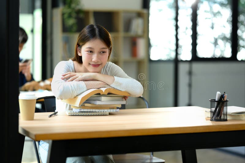 Smiling Collage Student Taking a Break from Studying Resting Her Head ...