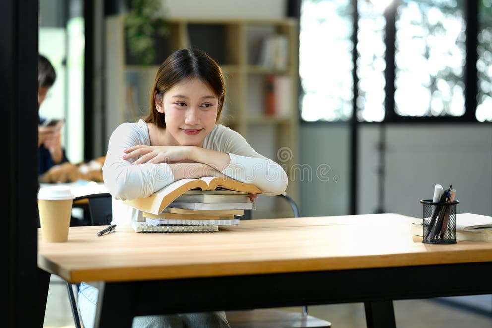 Smiling Collage Student Taking a Break from Studying Resting Her Head ...