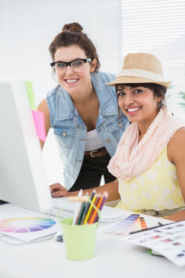 Smiling Colleagues Brainstorming and Using Computer Stock Image - Image ...