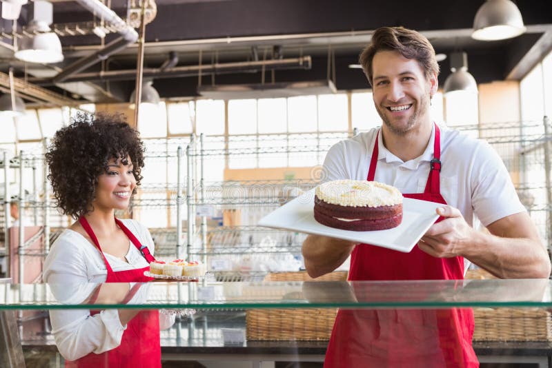 Smiling Colleagues in Uniform Showing Cakes Stock Photo - Image of cake ...