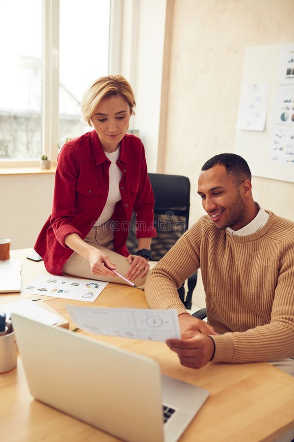 Smiling Colleagues Working at Office. Happy Business Couple Discussing ... Smiling Colleagues Working at Office. Happy Business Couple Discussing ...
