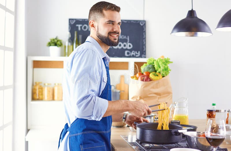 Smiling and Confident Chef Standing in Large Kitchen Stock Photo ...
