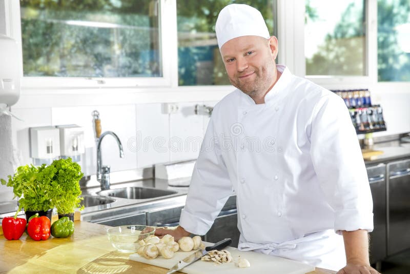 Smiling and Confident Chef Standing in Large Kitchen Stock Photo ...
