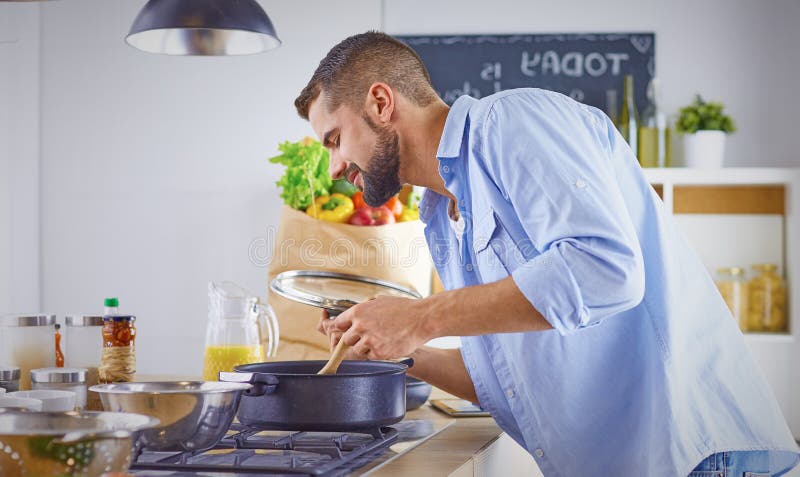Smiling and Confident Chef Standing in a Large Kitchen Tasting Stock ...