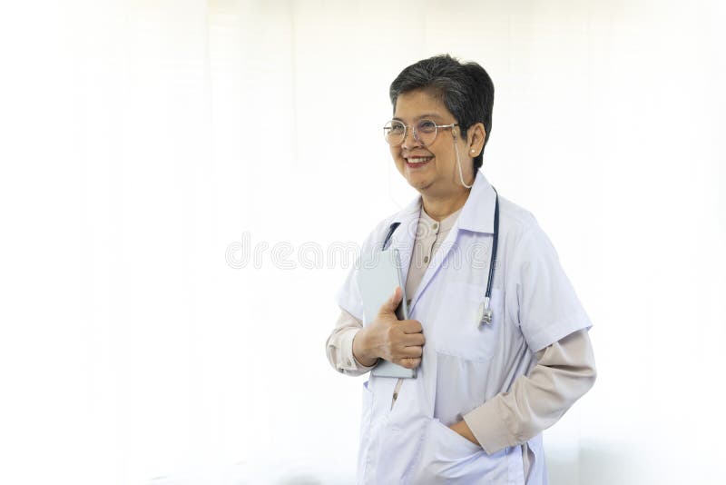 Confident Senior Female Doctor Happy Using Tablet Computer Standing in ...