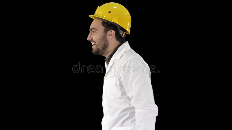 Smiling Construction Engineer Catching a Cap and Putting it on on a ...