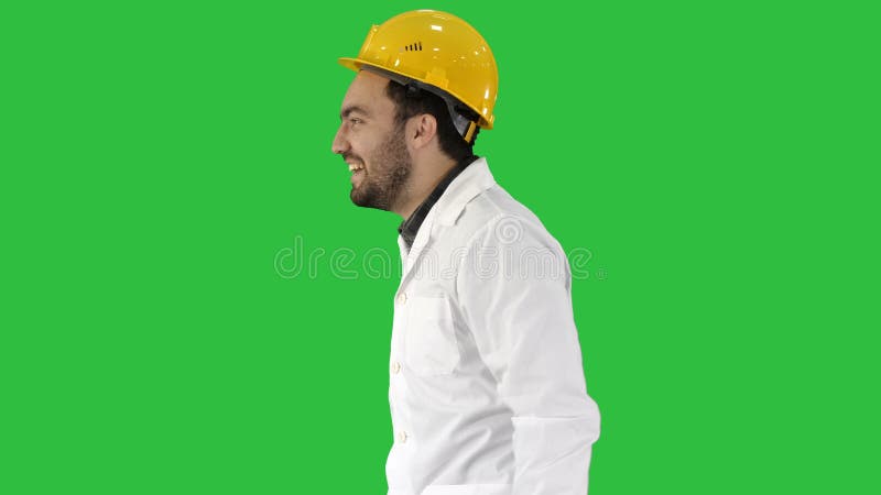 Smiling Construction Engineer Catching a Cap and Putting it on on a ...