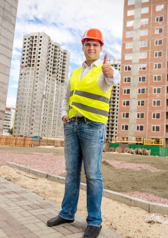Smiling Construction Engineer Posing on Building Site with Thumb Stock ...