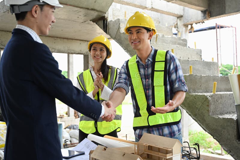 Smiling Construction Manager or Engineer Shaking Hands with Investor at ...