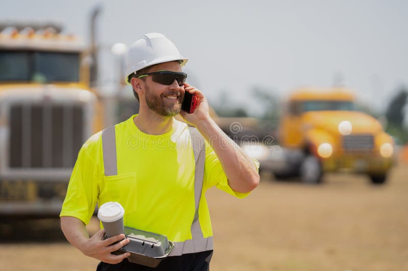Smiling Construction Site and Worker with Coffee. Caucasian ...