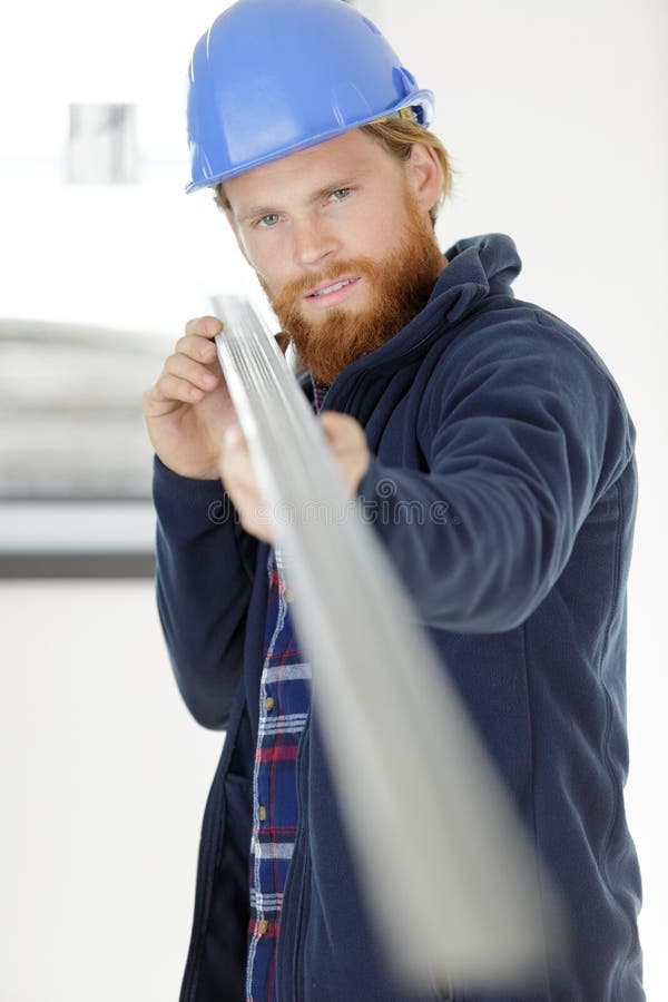 Smiling Construction Worker Carrying Metal Bar Stock Image - Image of ...