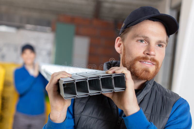 Smiling Construction Worker Carrying Metal Bar Stock Image - Image of ...