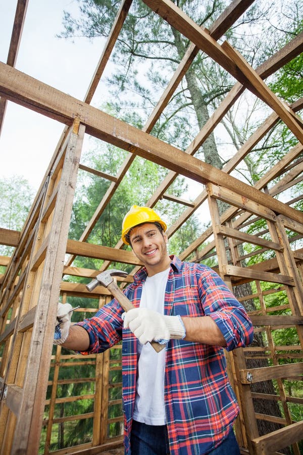 Smiling Construction Worker Hammering in Timber Stock Image - Image of ...