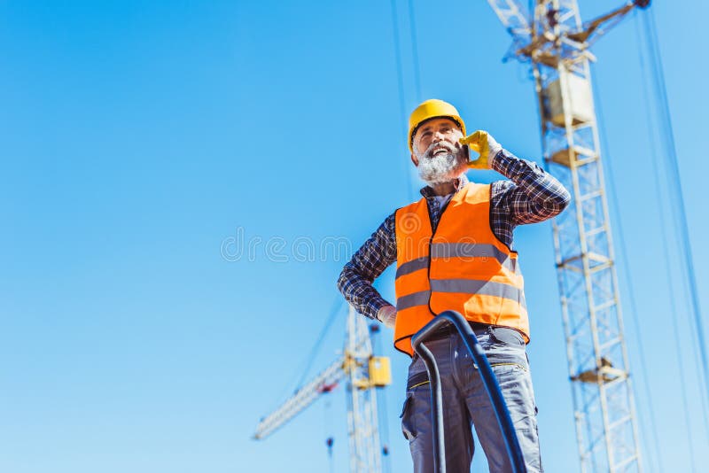 Smiling Construction Worker in Reflective Vest and Hardhat Talking ...