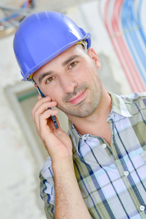 Smiling Construction Worker on Telephone Stock Photo - Image of ...