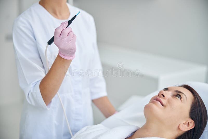 Pleased Woman Being Treated By A Professional Dermatologist Stock Image
