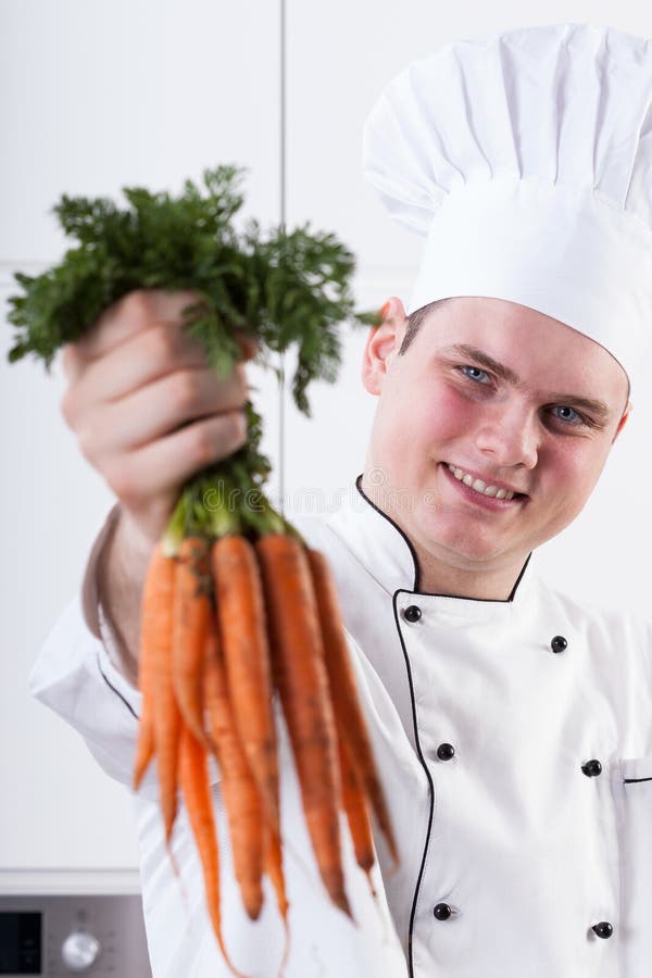Smiling cook with carrots stock photo. Image of chef - 41343406