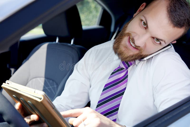 Smiling Cool Young Business Man at Work in Car with Technology Stock ...