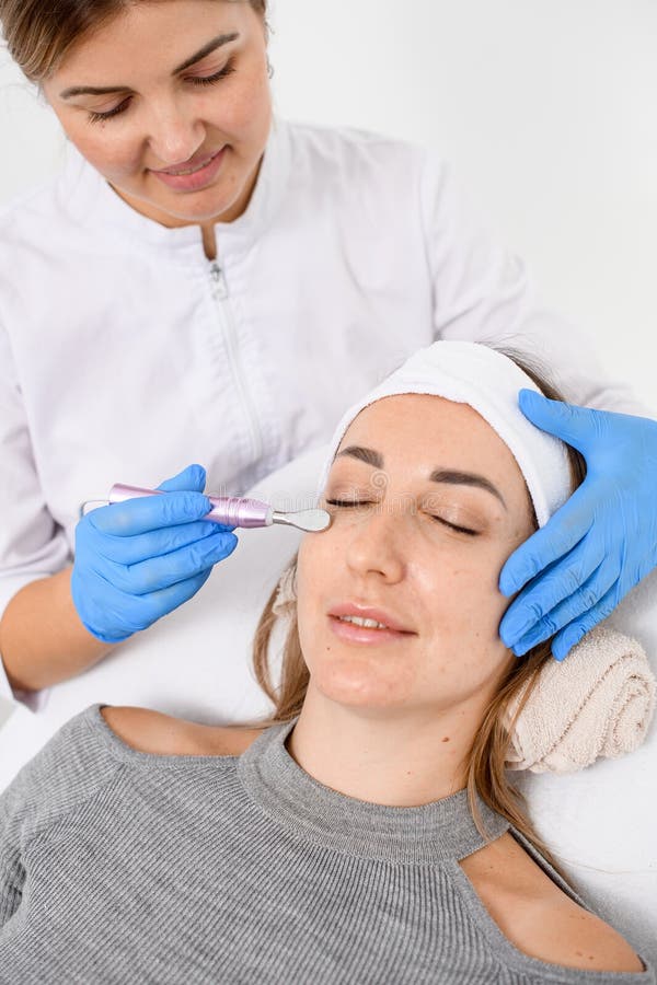 Smiling Cosmetologist Performs the Procedure of Electroporation of the ...