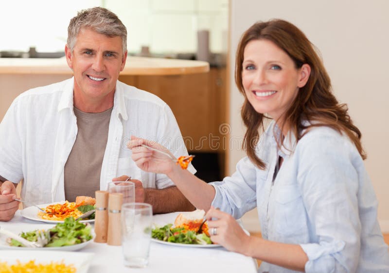 Smiling Couple Eating Dinner Stock Image - Image of interior, festive ...