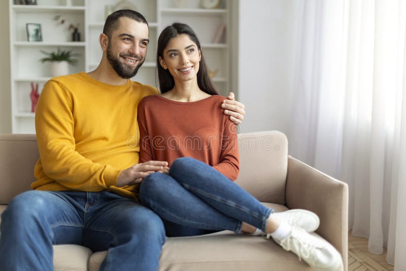 Couple Chatting on a Couch Looking Happy Stock Image - Image of married ...