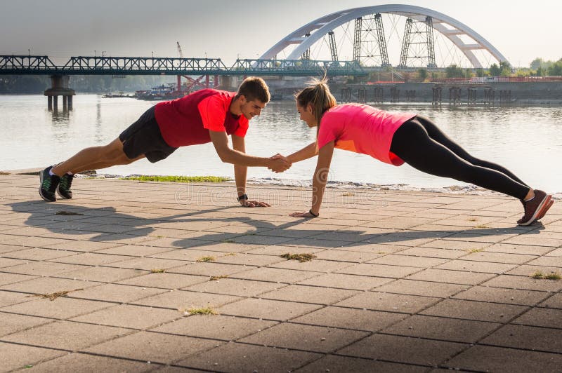 Fit Couple Exercises Outdoors: Man Doing Push-ups with Woman on His ...