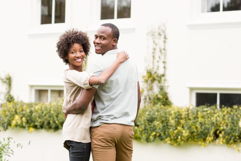 Smiling Couple Looking Back at the Camera Stock Photo - Image of garden ...