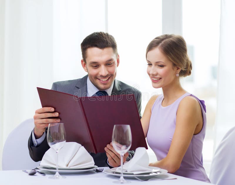 Smiling Couple with Menu at Restaurant Stock Photo - Image of meal ...