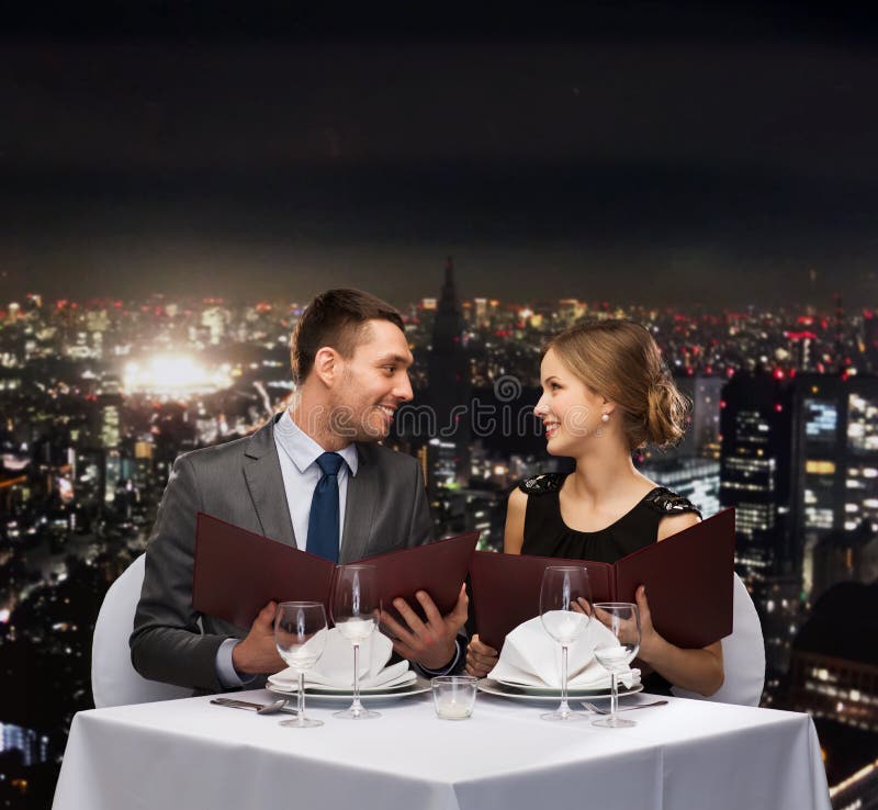 Smiling Couple with Menus at Restaurant Stock Photo - Image of birthday ...