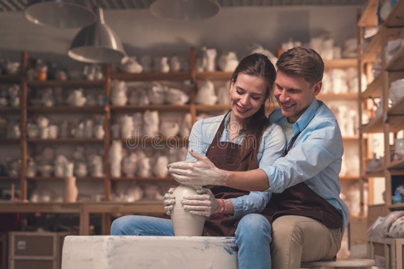 Smiling couple in pottery stock image. Image of romantic - 116342237