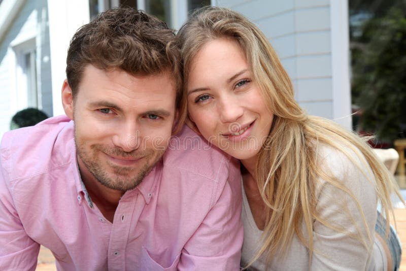 Smiling Couple Sitting in Front of Their House Stock Image - Image of ...