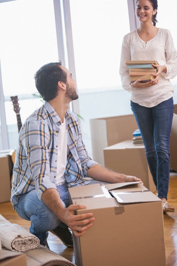 Smiling Couple Unpacking Cardboard Boxes Stock Image - Image of ...