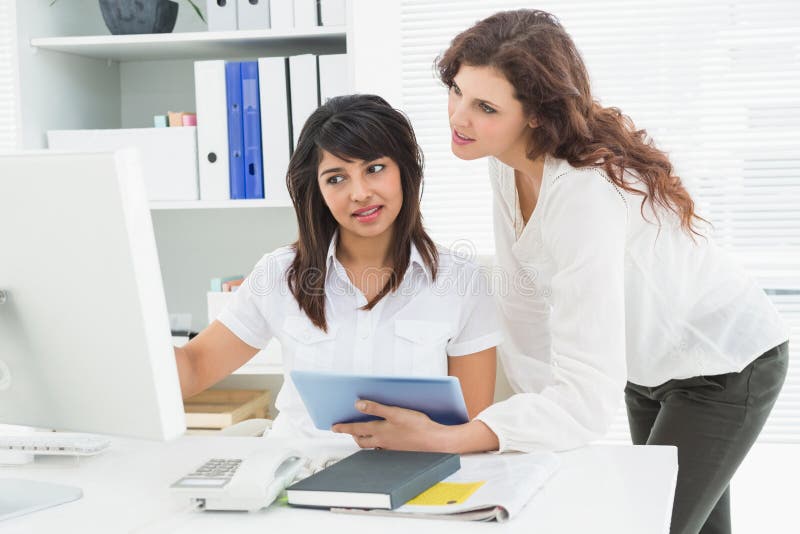 Smiling Coworkers Using Computer and Tablet Pc Stock Image - Image of ...