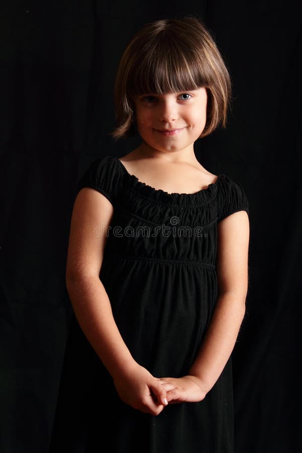 Smiling Coy Child in Black stock photo. Image of close - 27479718