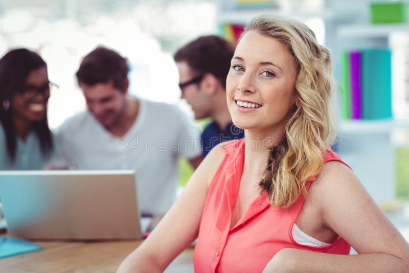 Smiling Creative Businesswoman Working with Co-workers Stock Photo ...