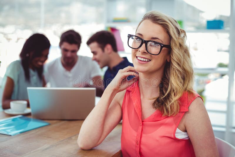 Smiling Creative Businesswoman Working with Co-workers Stock Photo ...