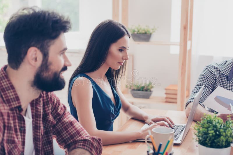 Smiling Creative Team with Laptop Working Hard in Office Stock Image ...