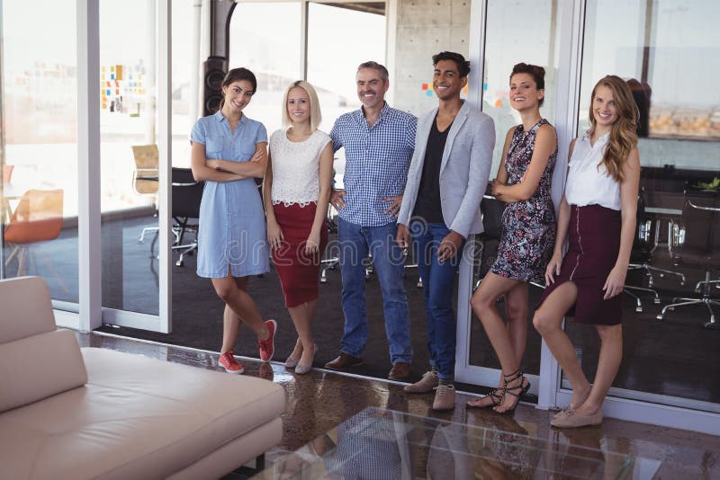 Smiling Creative Team Standing Together at Office Stock Image - Image ...