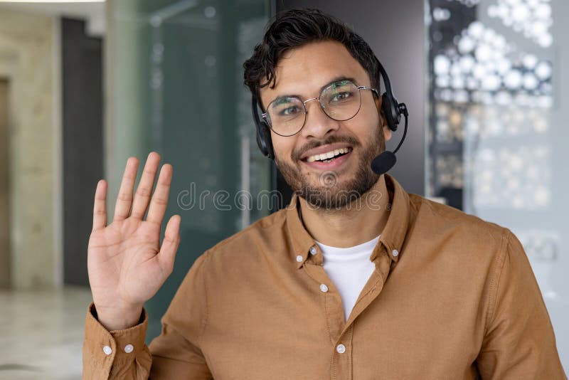 Friendly Customer Service Representative with Headset Waving and ...