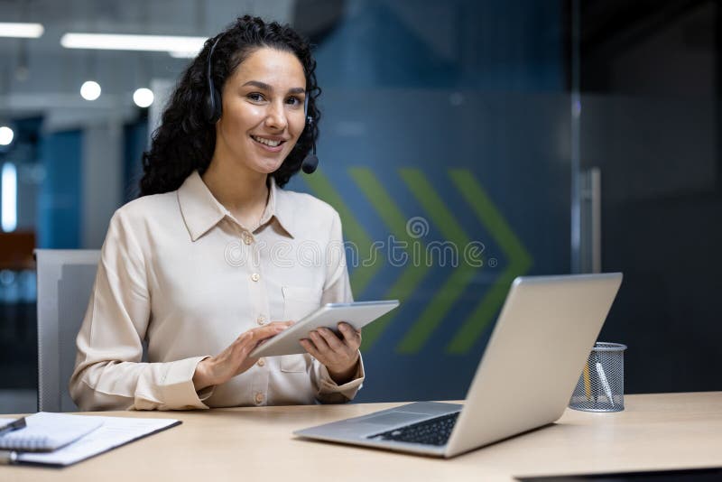 Smiling Customer Service Representative Using Tablet and Laptop at ...