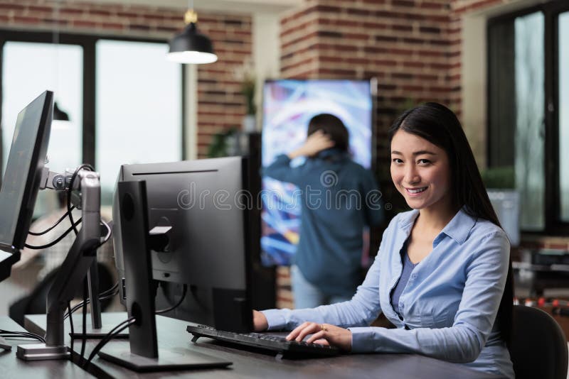 Smiling 3D Artist and Developer Sitting at Desk in Office Workspace ...