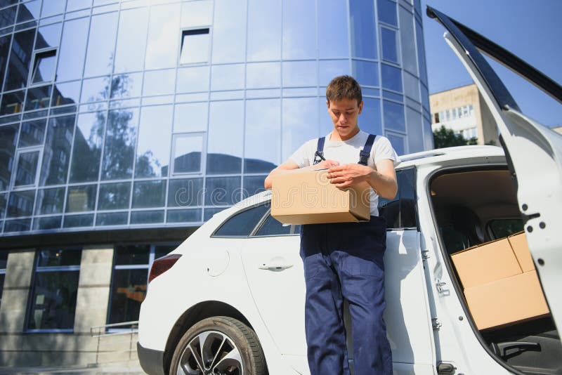 Smiling Delivery Man Holding a Paper Box Stock Image - Image of office ...