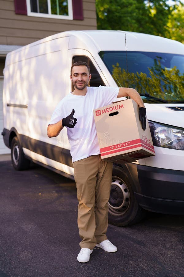 Smiling Delivery Man Holding Paper Box Thumbs Up Stock Photos - Free ...