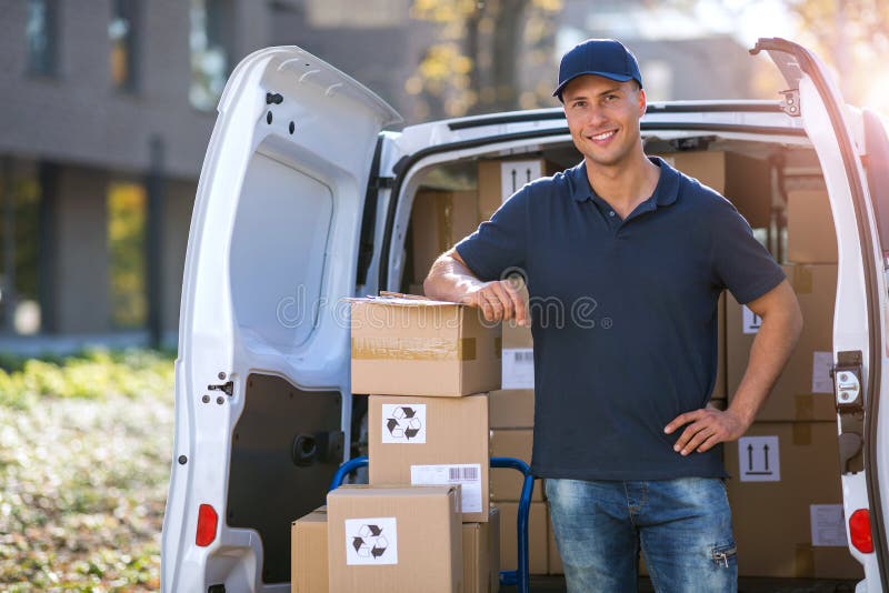 Smiling Delivery Man Loading Boxes into His Truck Stock Image - Image ...