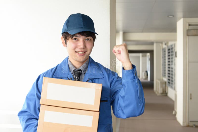Smiling delivery man stock photo. Image of adult, asian - 126134190